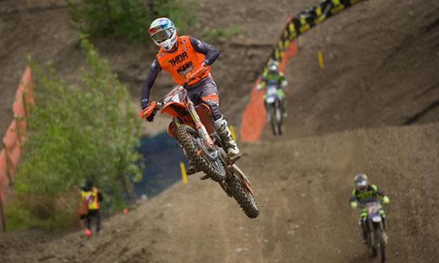 Cole Thompson climbs on top of the podim and grabs the Red Plate back ...